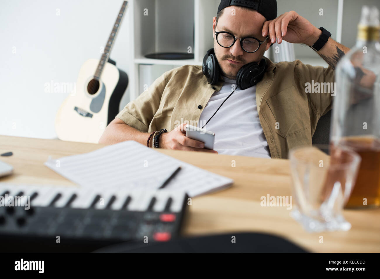 overworked musician using smartphone Stock Photo - Alamy