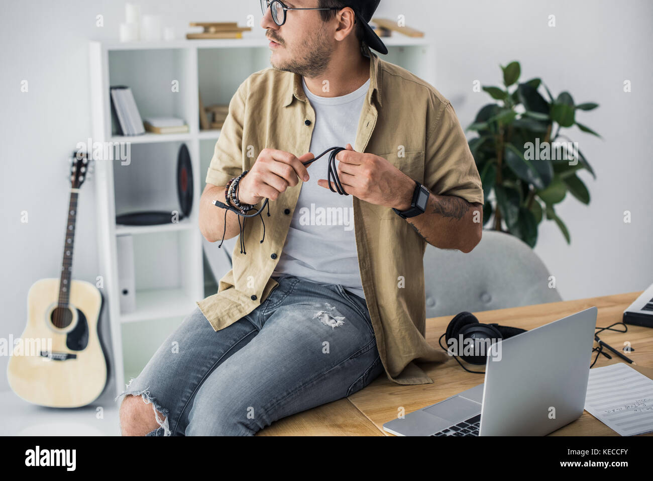 man sitting on worktable Stock Photo - Alamy