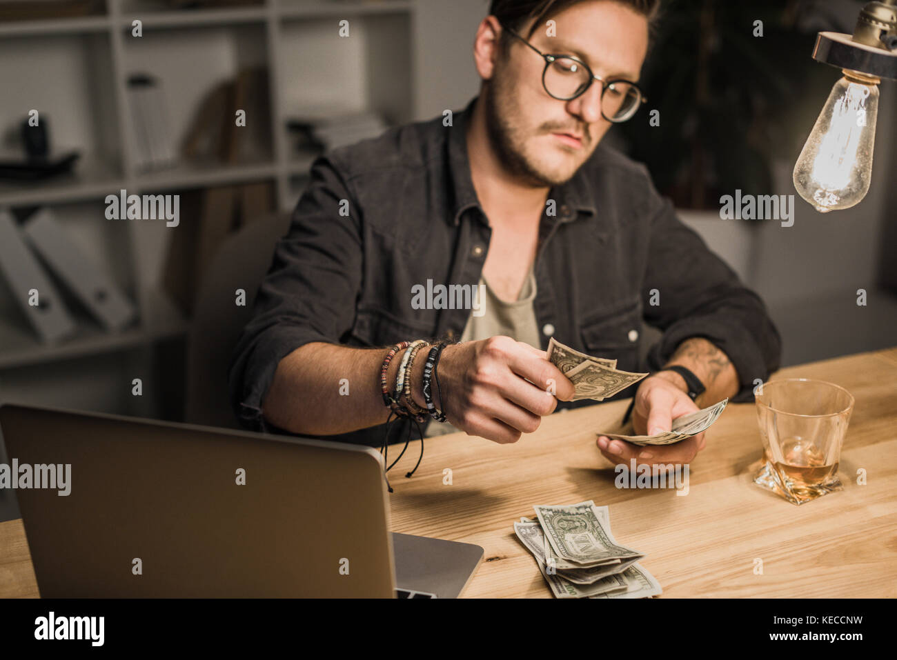 handsome man counting cash Stock Photo - Alamy