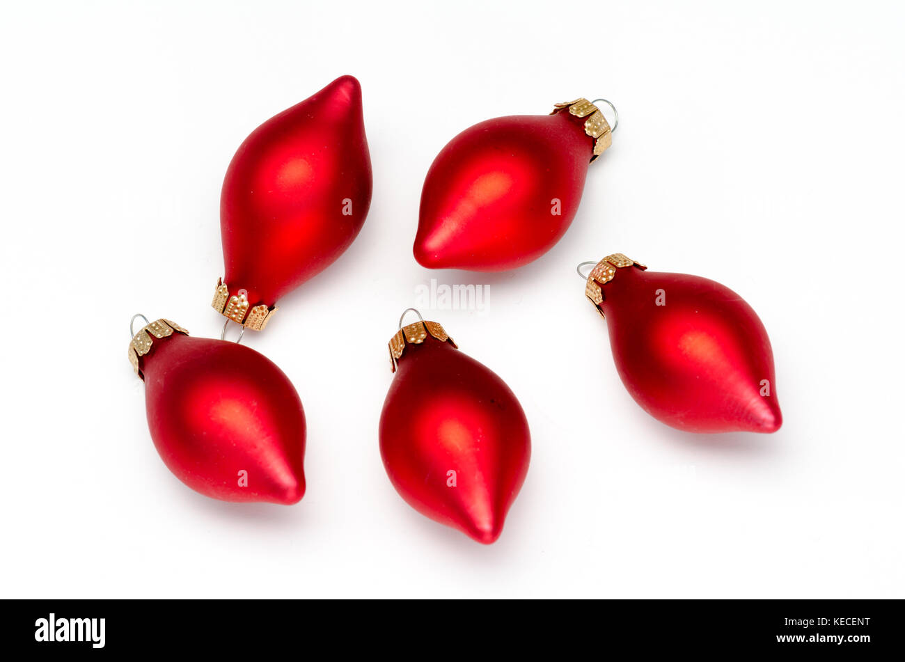 five red drop-shaped christmas tree balls on white background Stock ...