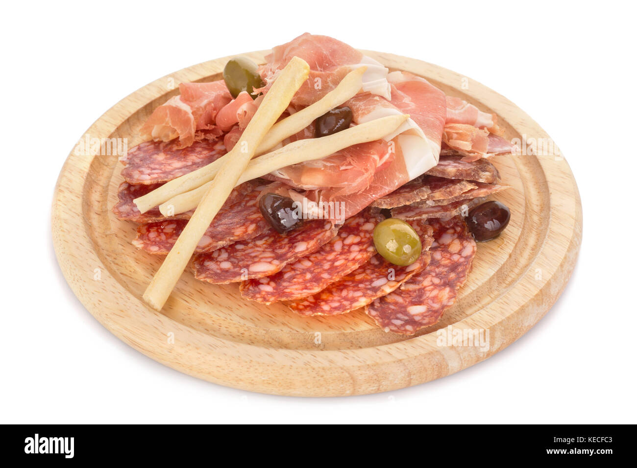 Dry-cured pork slices on wooden plate isolated Stock Photo - Alamy