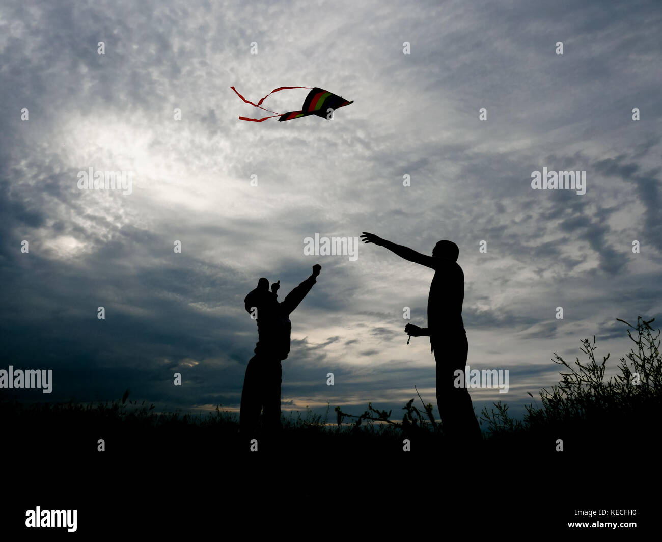 happy father and son launching a kite at beautiful sunset Stock Photo ...