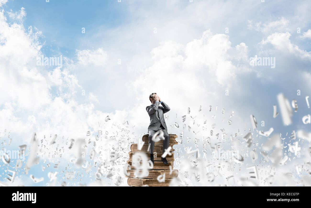 Young man floating in sky and do not want to see anything Stock Photo ...