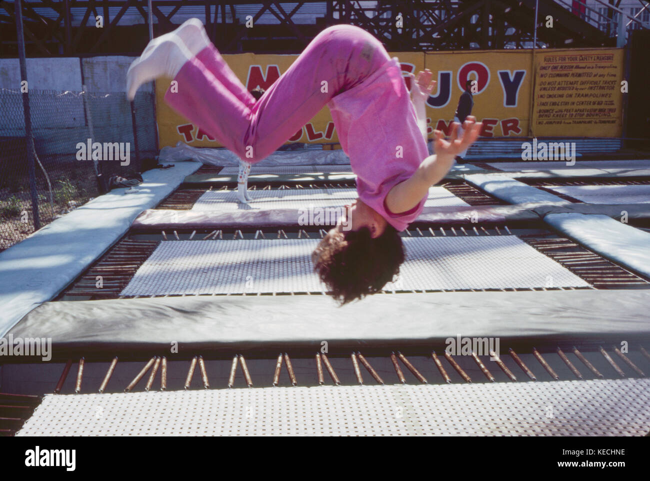 Girl Flipping on Amusement Park Trampoline, Coney Island, New York, USA ...