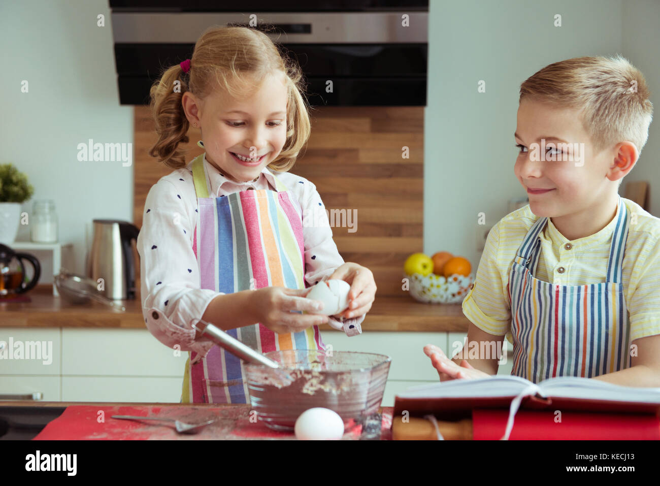 Portrait of two happy children which having fun during cooking ...