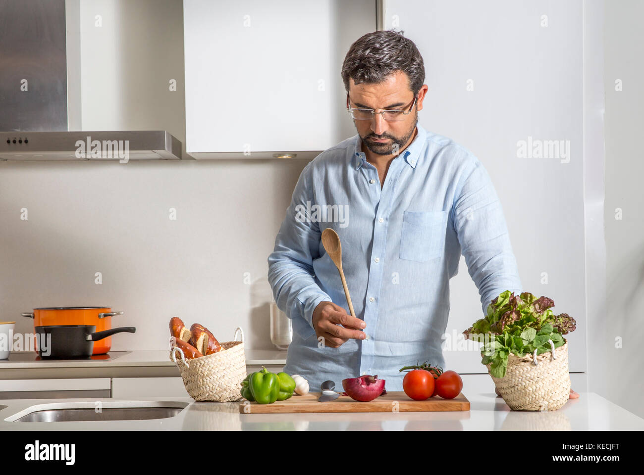 arab man preparing food in his bright urban apartment Stock Photo - Alamy