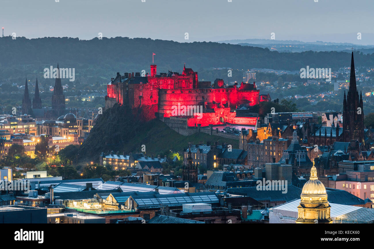 View of Edinburgh Castle illuminated in red in the evening from ...