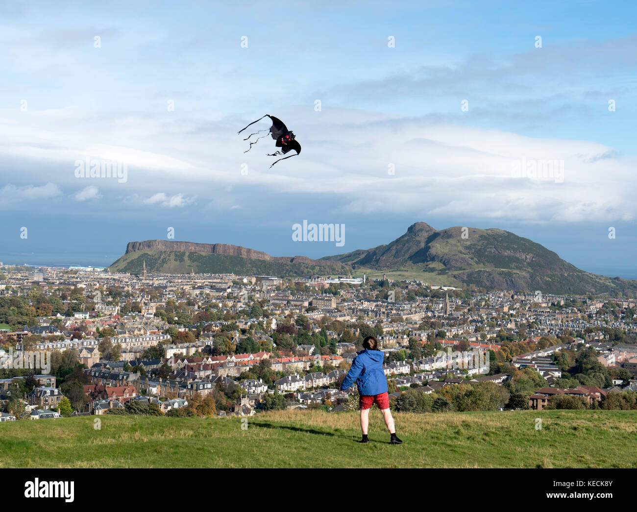 View of boy flying kite and Salisbury Crags and Arthur's Seat hill ...