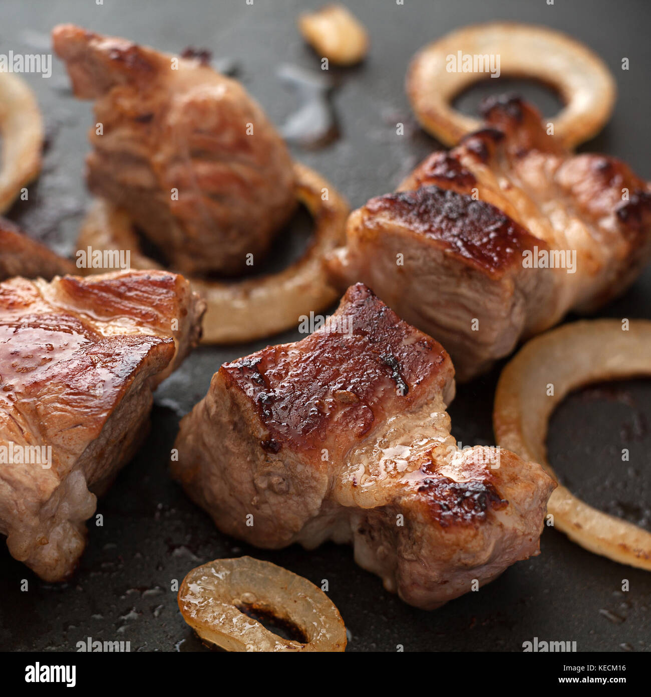 Grilled meat with orion rings on grill table Stock Photo - Alamy