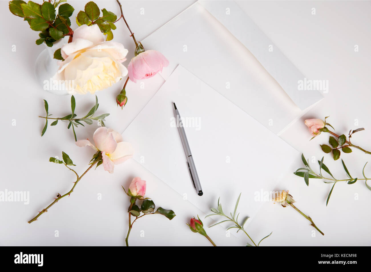 Flat lay shot of letter and white envelope on white background with ...