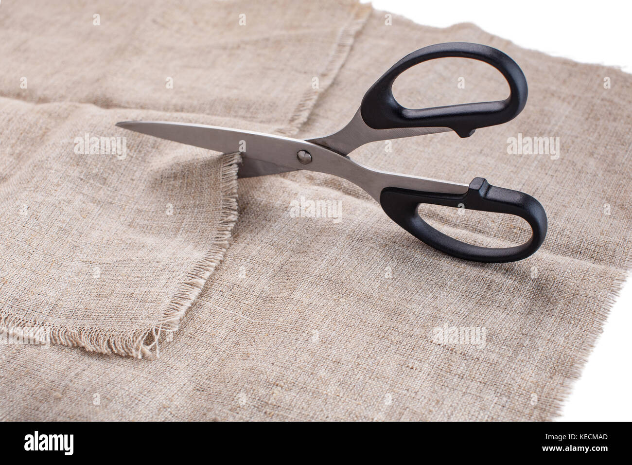 The tailor's scissors cut linen fabric on a white background Stock ...