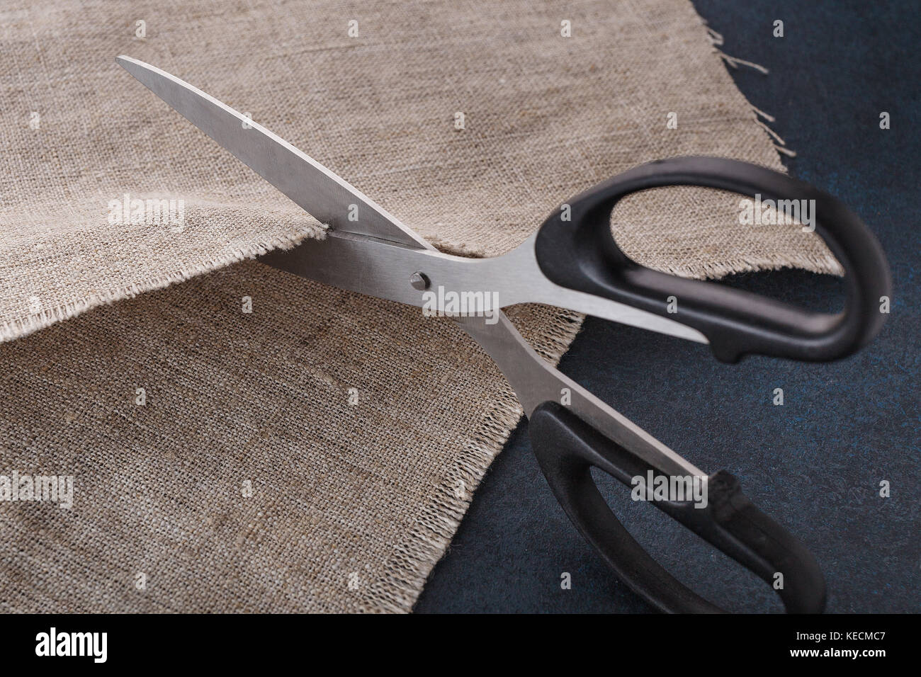 The tailor's scissors cut linen cloth Stock Photo - Alamy