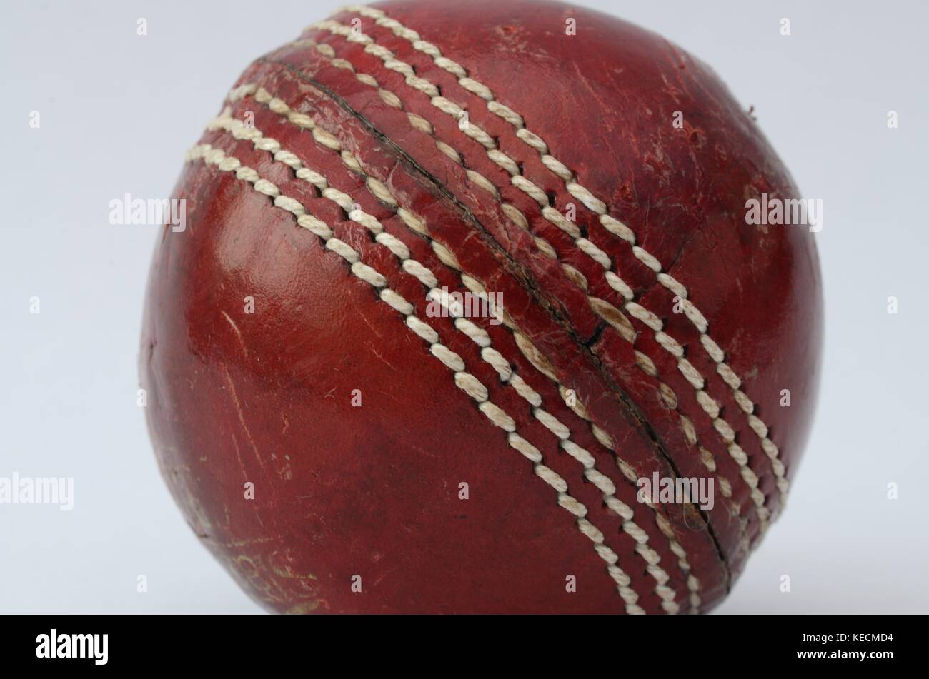 Close up of a classic red English Cricket Ball on white background ...
