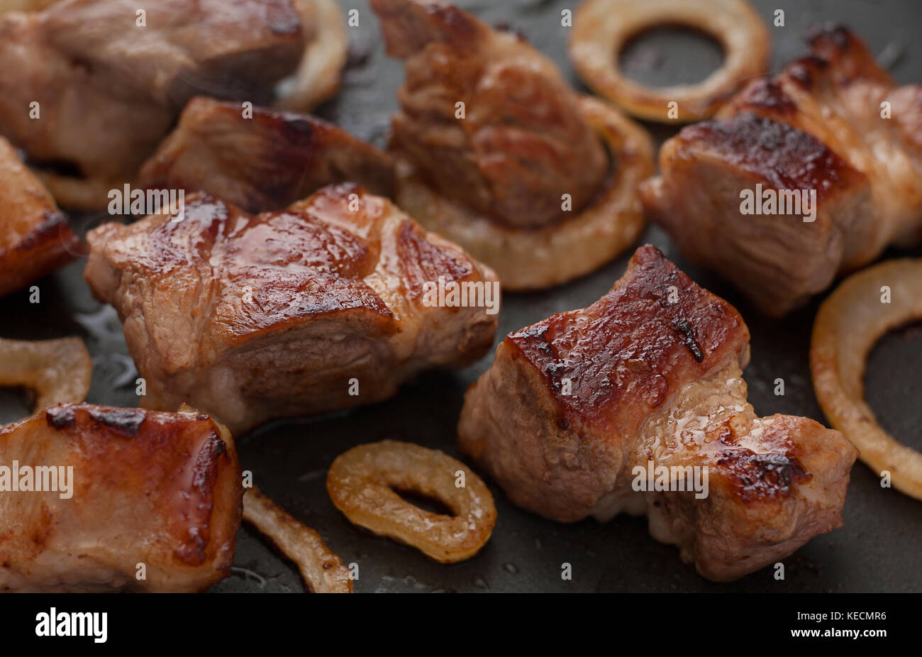 Grilled meat with orion rings on grill table Stock Photo - Alamy