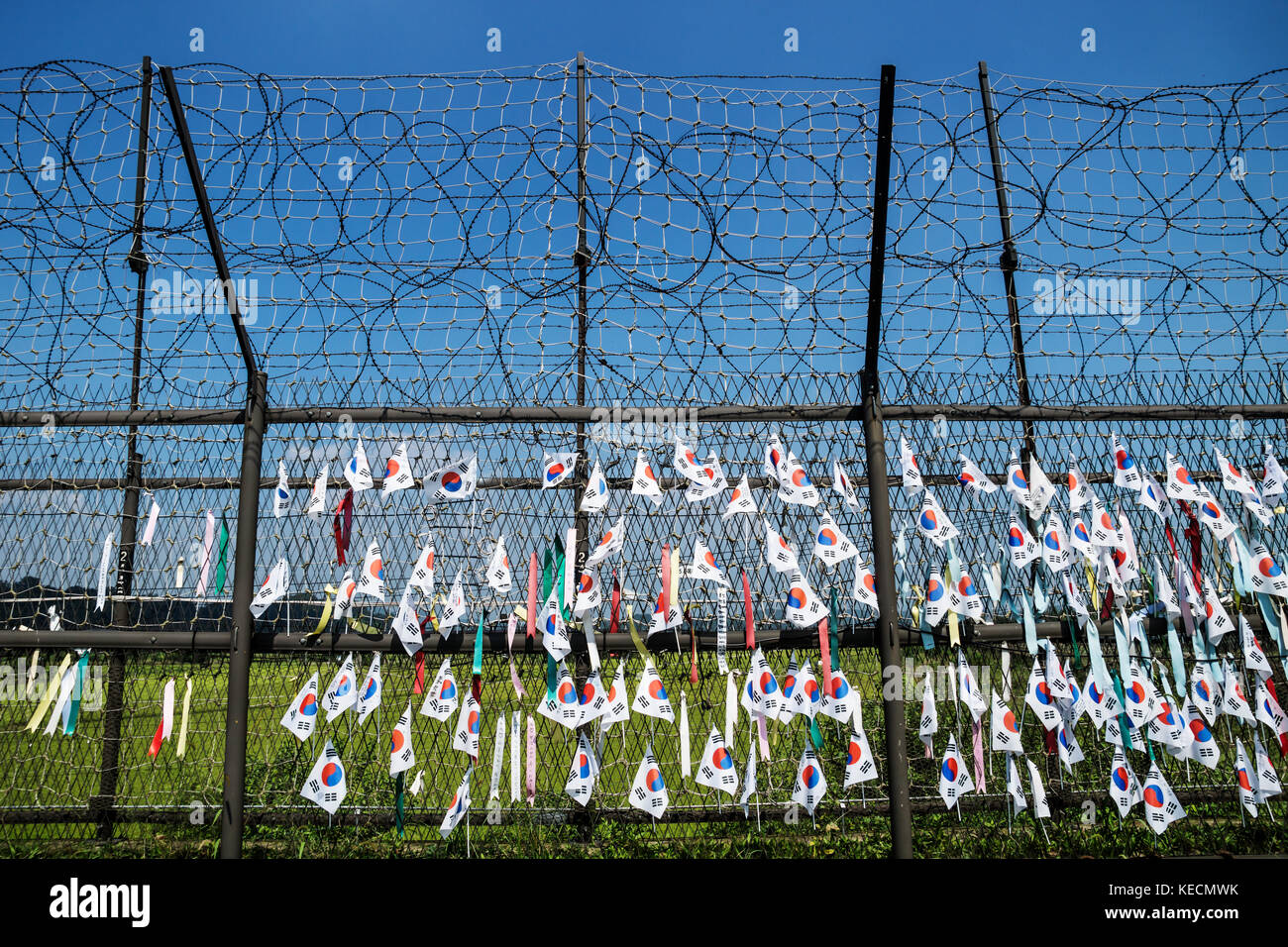 Fence with barbed wire and south korean flags at the demilitarised zone ...
