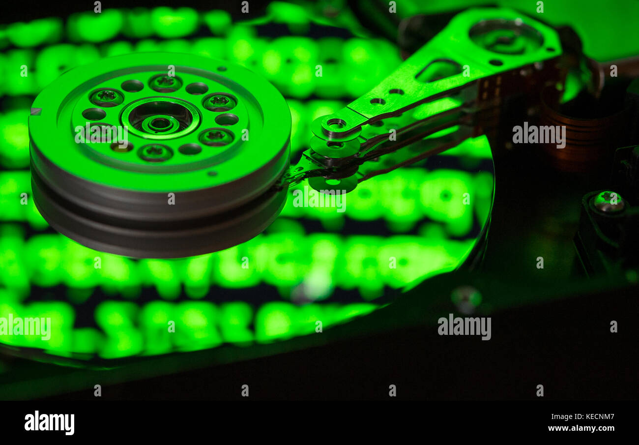 Illustration - Reflections of computer code in green writing on disc of ...