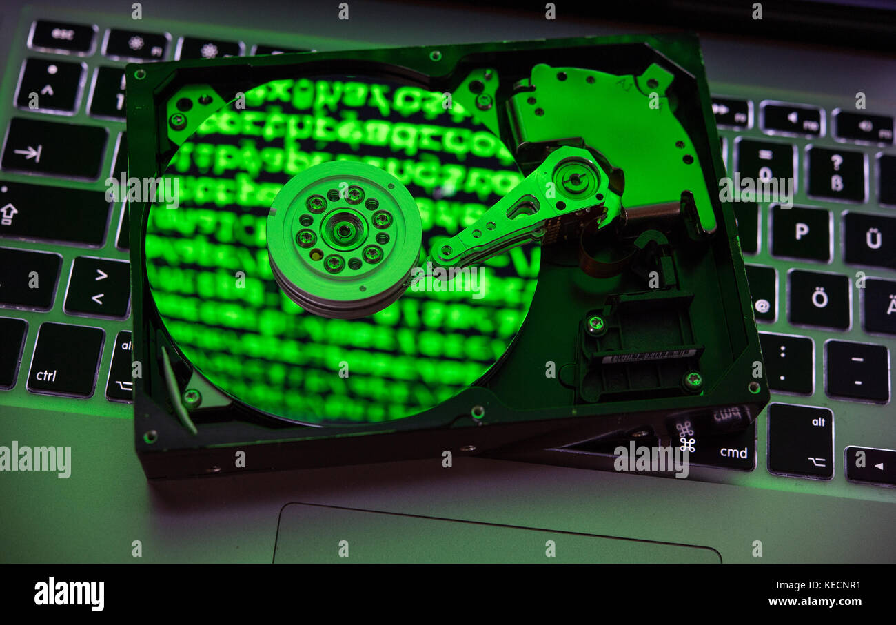 Illustration - Reflections of computer code in green writing on disc of ...