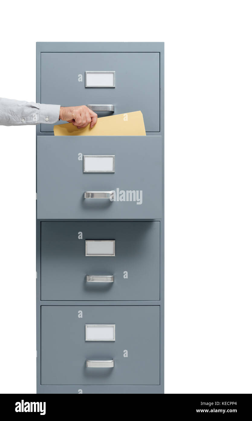 Office worker taking a file from a filing cabinet drawer, business and ...