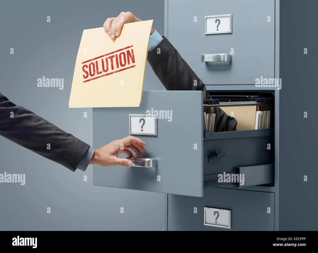 Businessman inside a filing cabinet giving a file with business ...