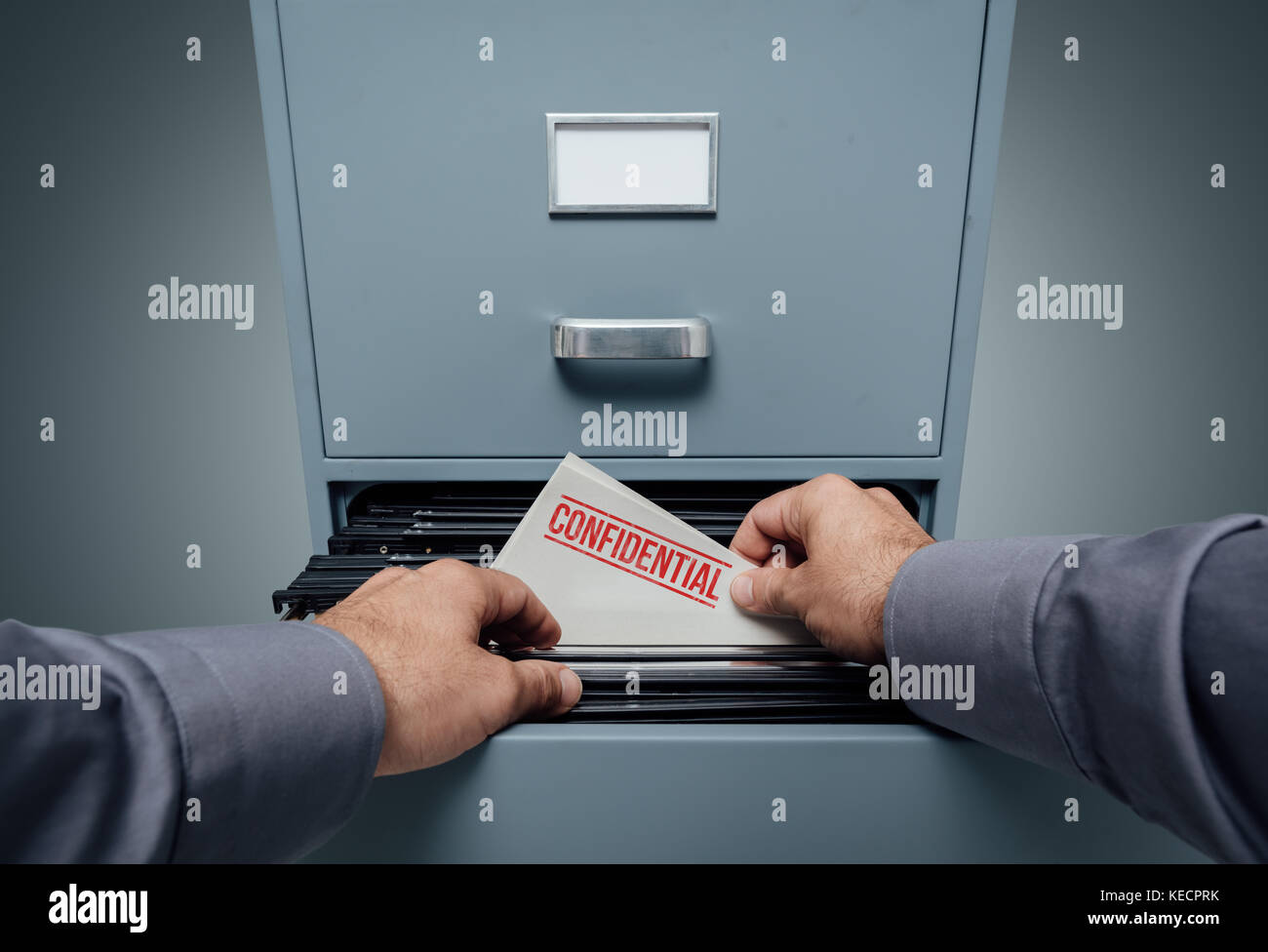 Office clerk searching for files in the filing cabinet, he finds a ...