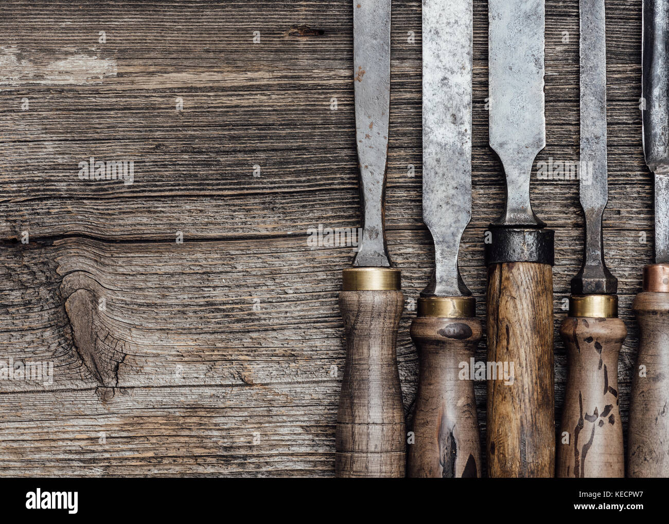 Set of used professional carving and woodworking tools on the workbench ...