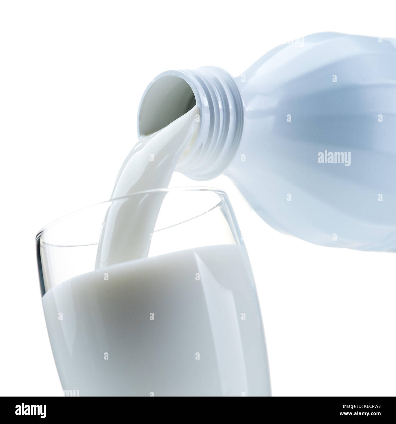 Pouring fresh milk from a bottle into a glass: dairy and nutrition ...
