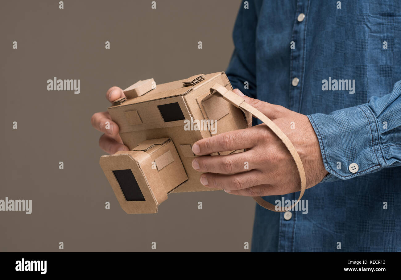 Photographer holding an handmade eco-friendly cardboard camera, crafts ...