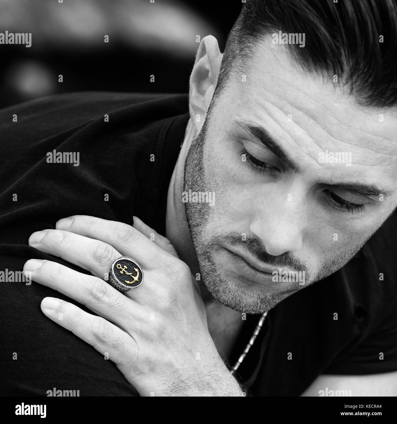 Portrait of a beautiful young man with ring decorated with anchor Stock ...