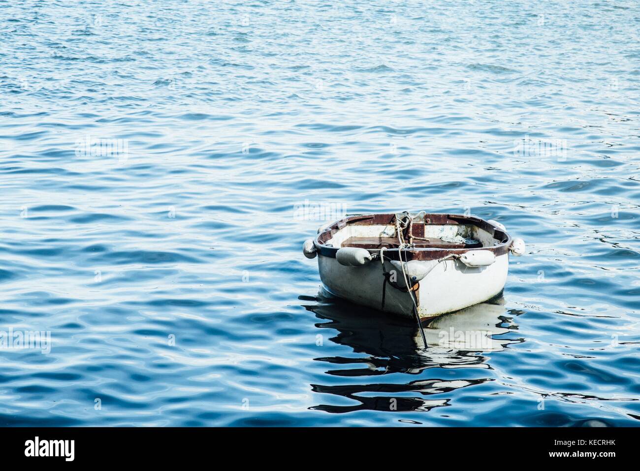 Rowing Boat resting on the water Stock Photo - Alamy