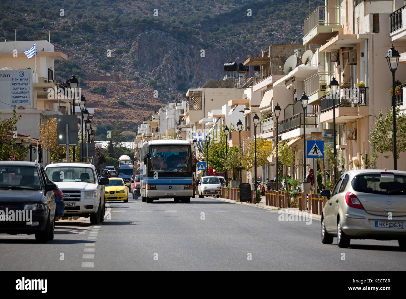 Main Street Malia, Crete, Greece. A tourist bus passing through this ...