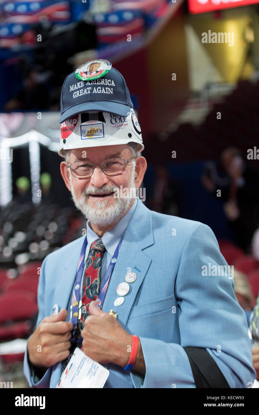 A GOP delegate wears several hats decorated with campaign buttons ...