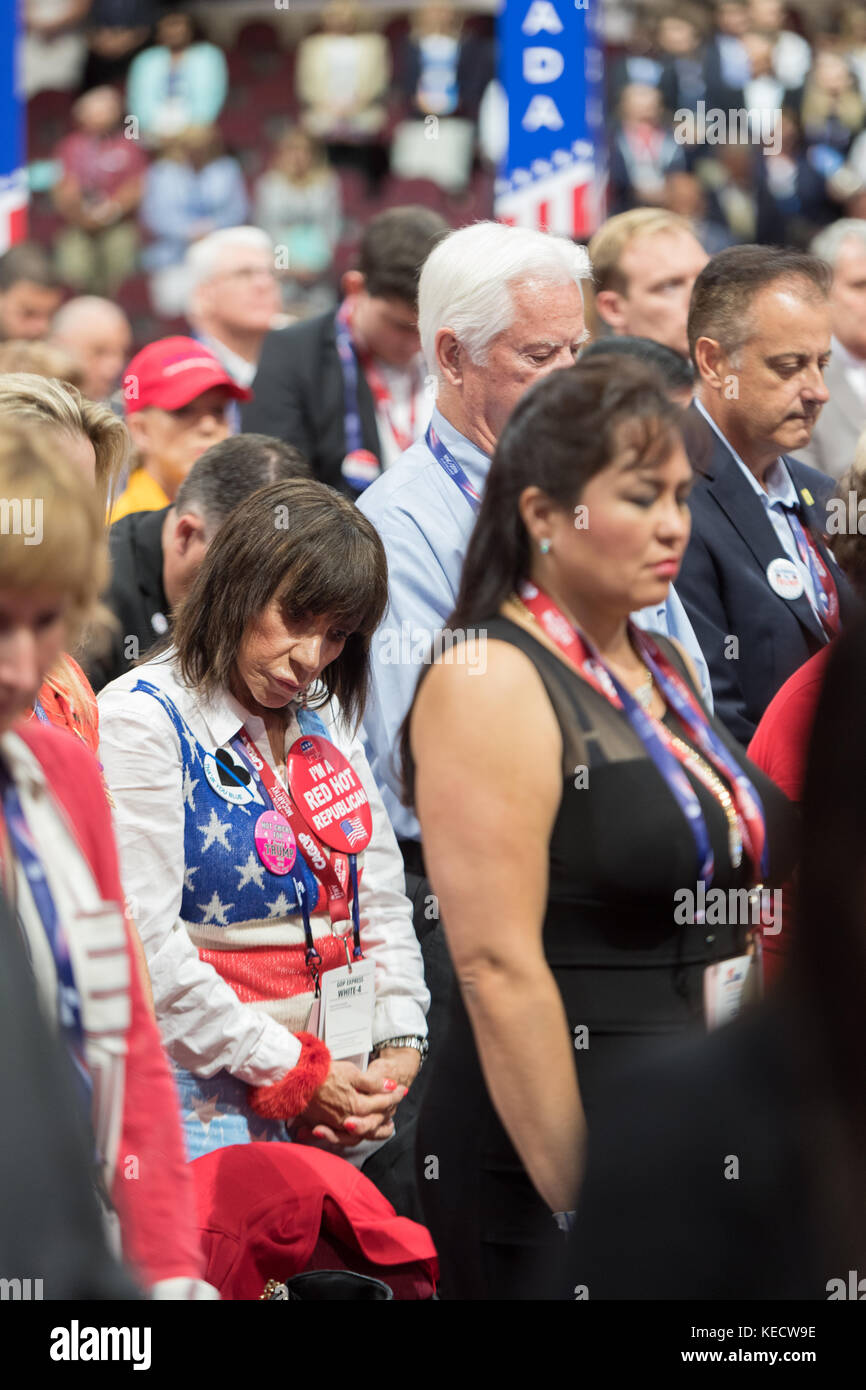A GOP delegate bow their heads in prayer during the Republican National ...