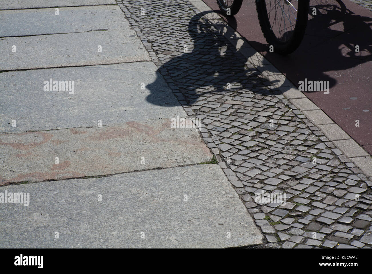 cyclist silhouette and shadow on bike lane Stock Photo - Alamy