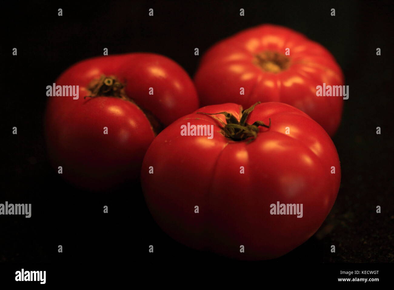 Three red heirloom tomatoes fresh from the garden Stock Photo - Alamy