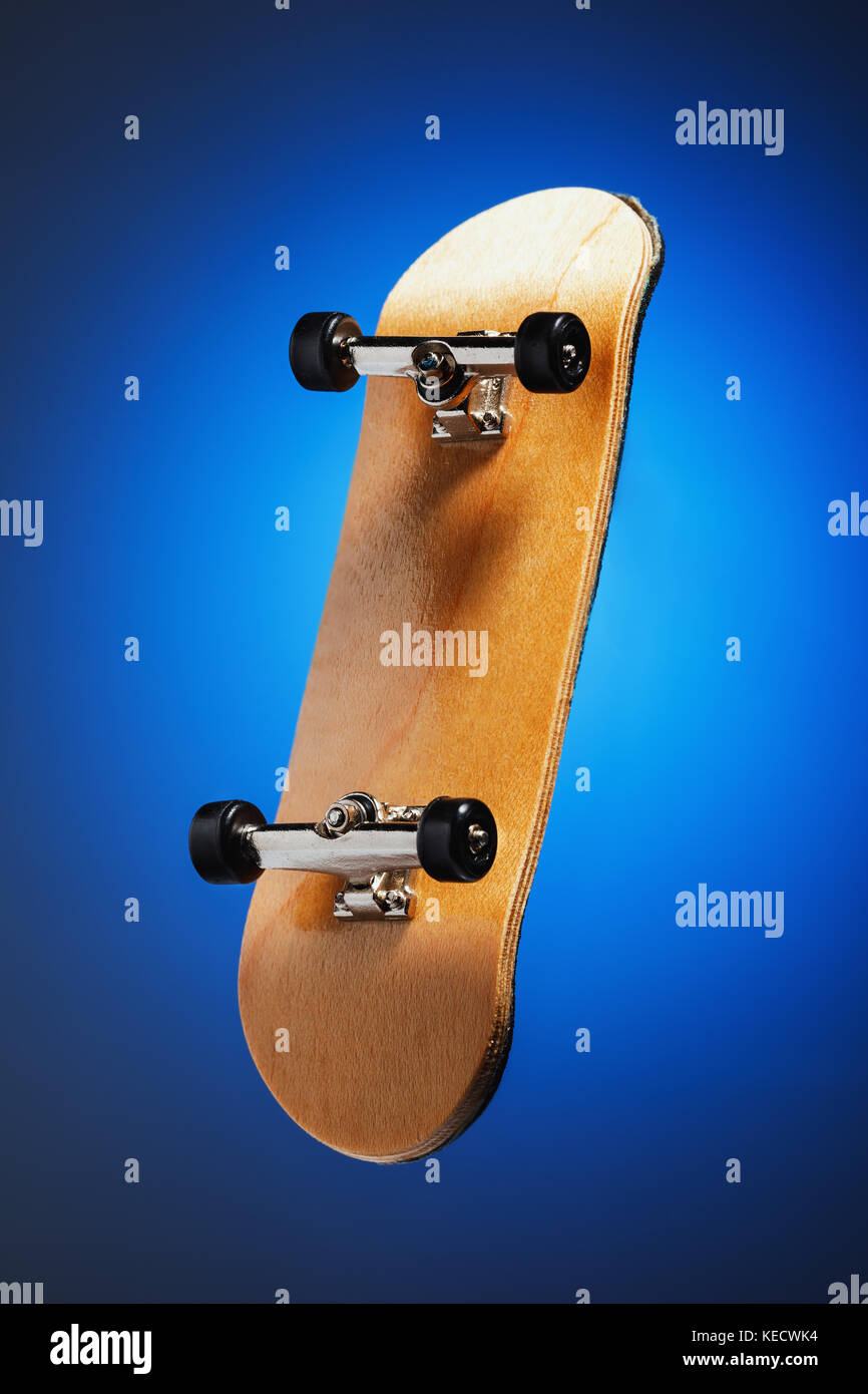 Fingerboard on a blue background, close-up Stock Photo - Alamy