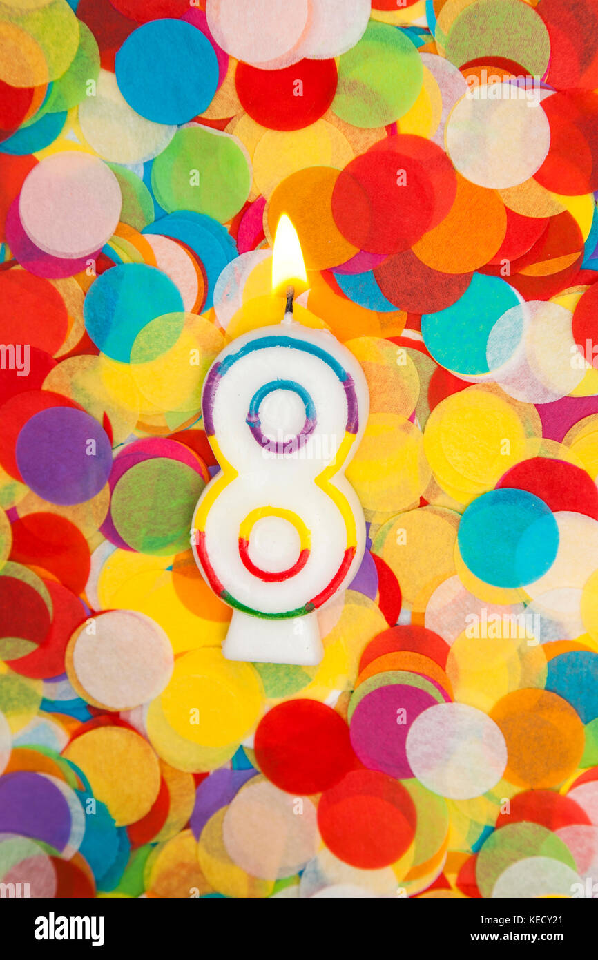 Celebration candle number 8 on a confetti background Stock Photo - Alamy
