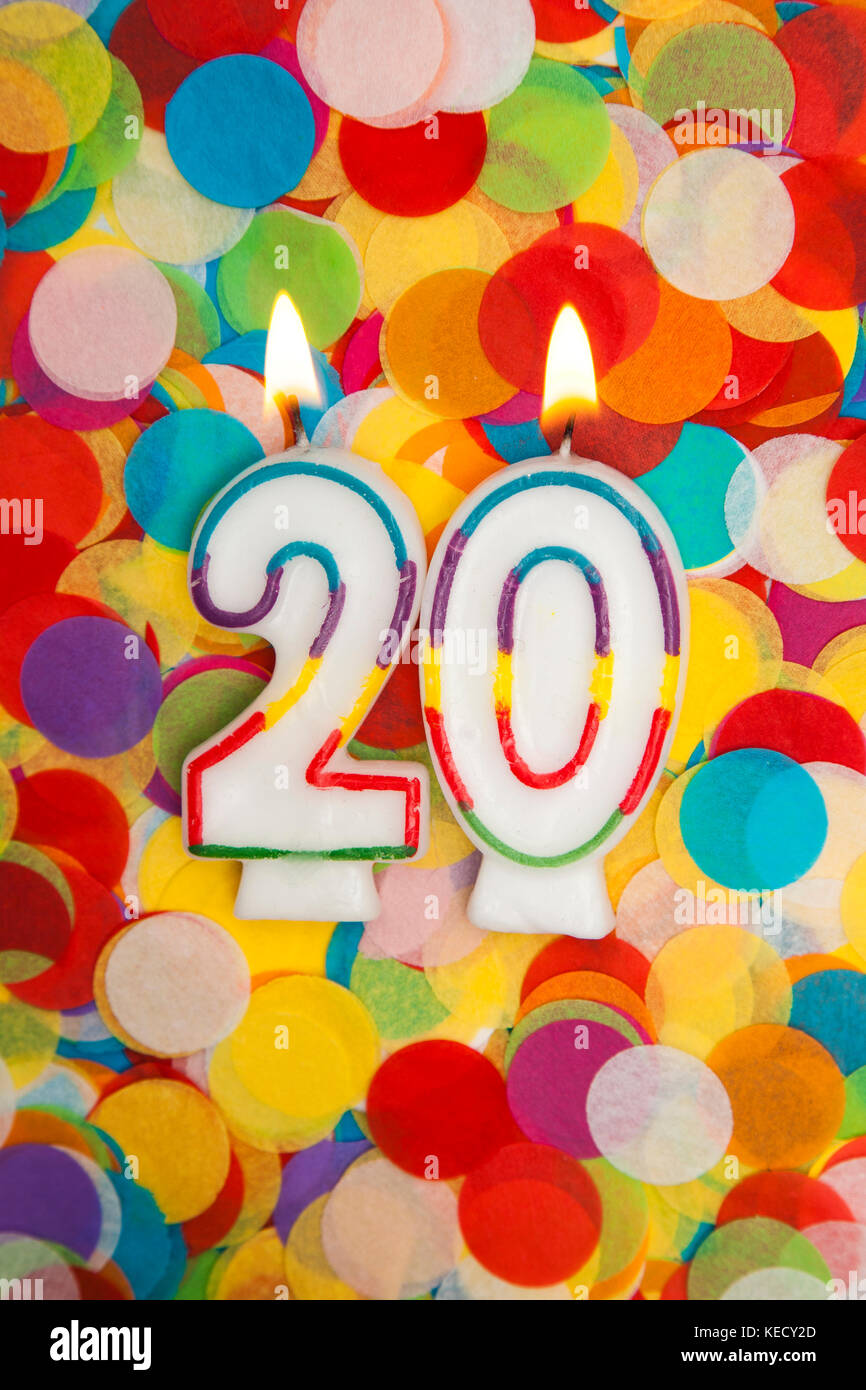Celebration candle number 20 on a confetti background Stock Photo - Alamy