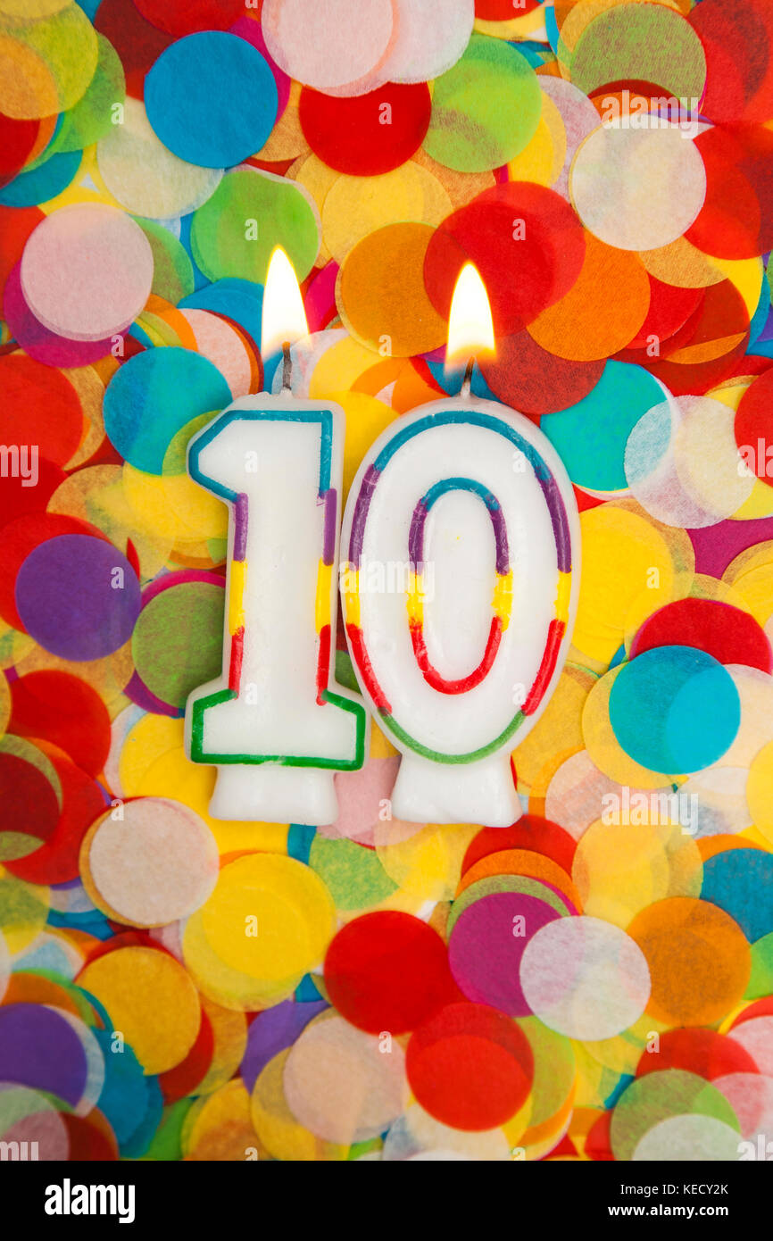 Celebration candle number 10 on a confetti background Stock Photo - Alamy