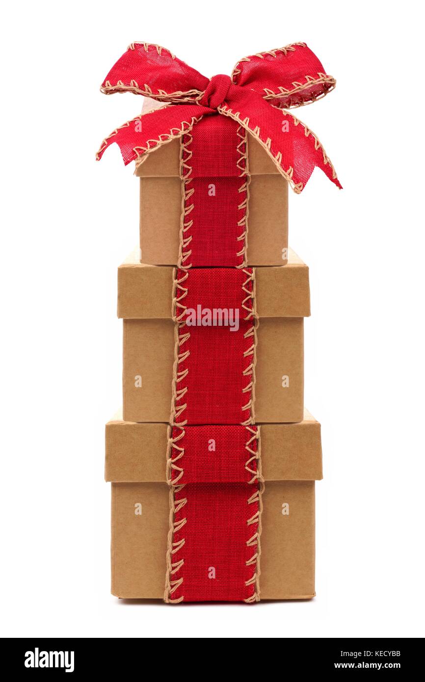 Stacked brown Christmas gift boxes wrapped with rustic red bow and ...