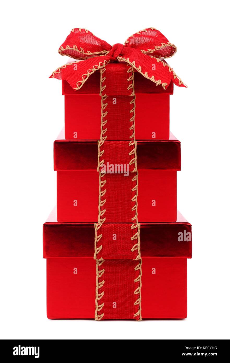Stacked red Christmas gift boxes wrapped with rustic red bow and ribbon ...