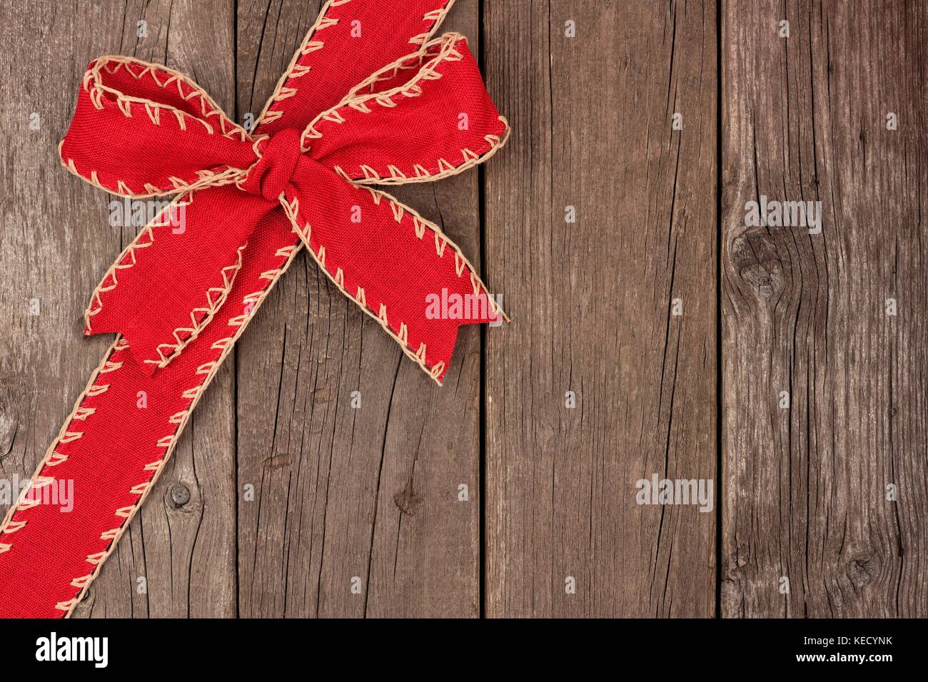 Rustic red Christmas bow and ribbon diagonal border, above view on an ...