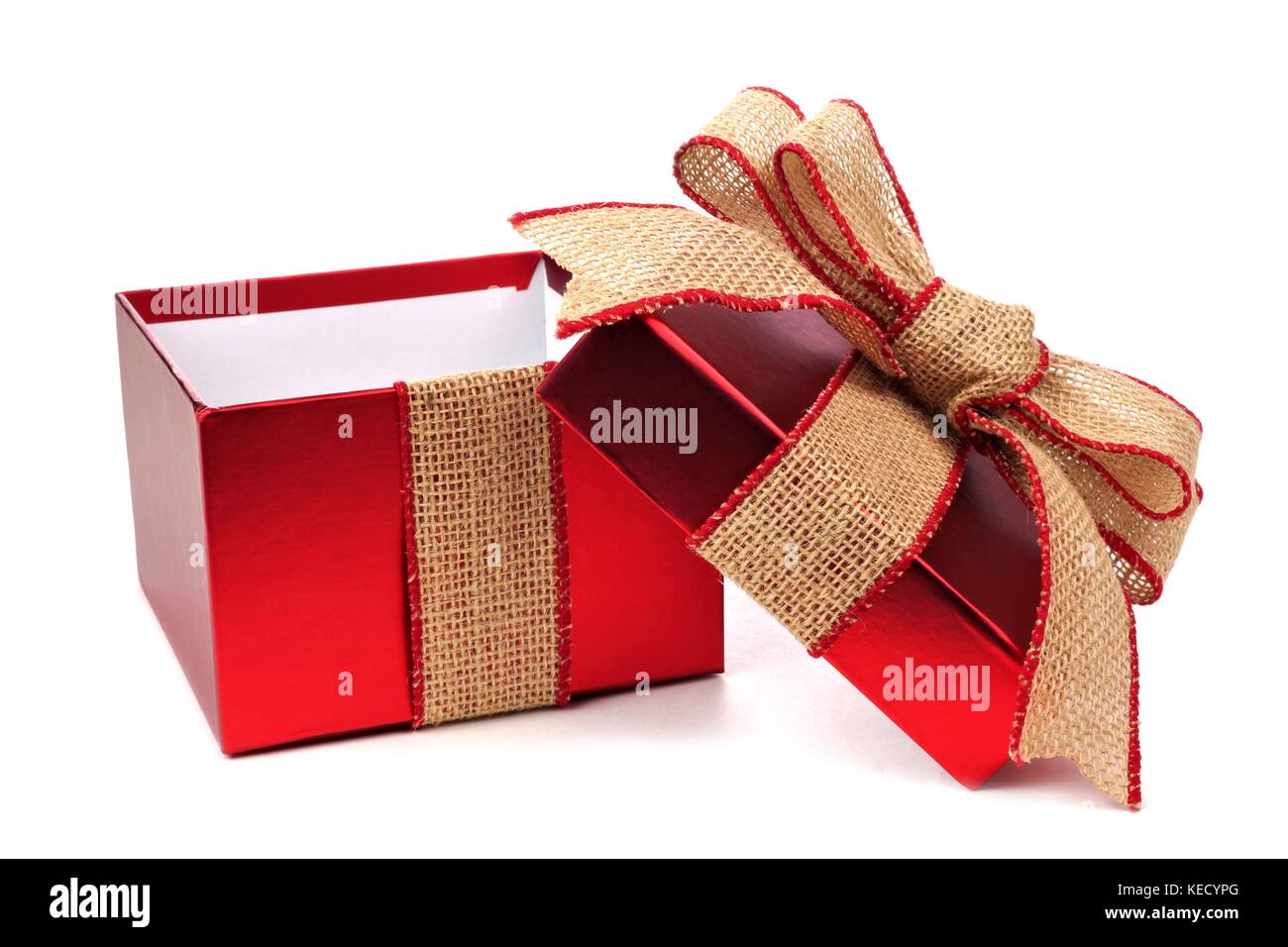 Opened red gift box wrapped with rustic burlap bow and ribbon isolated ...