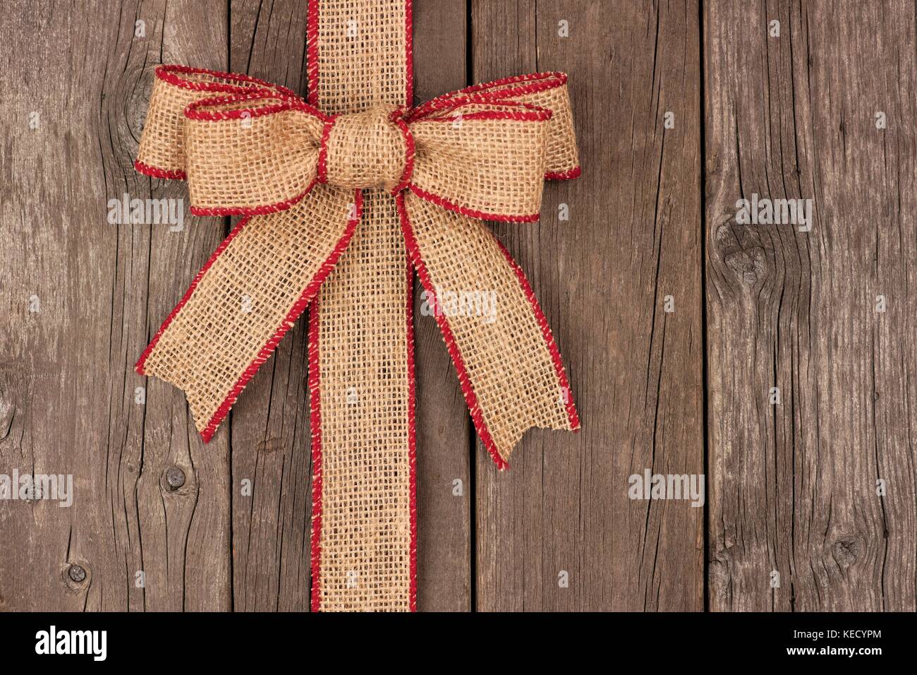 Burlap Christmas bow and ribbon side border, above view on a rustic ...