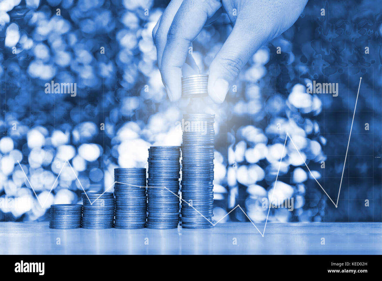 Double exposure of woman hand put coin on step of coins stacks on table ...