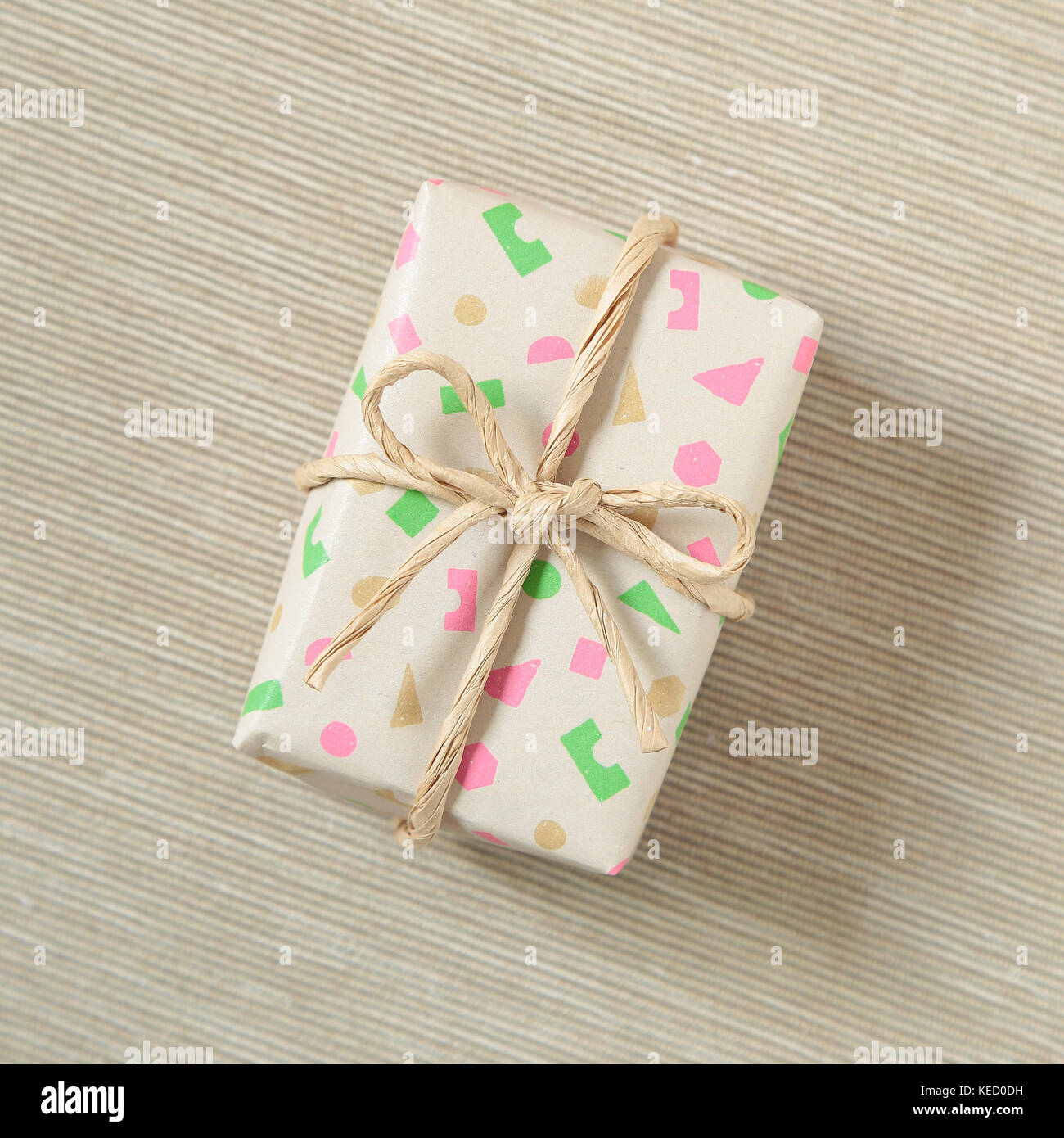 gift on beige fabric background Stock Photo - Alamy