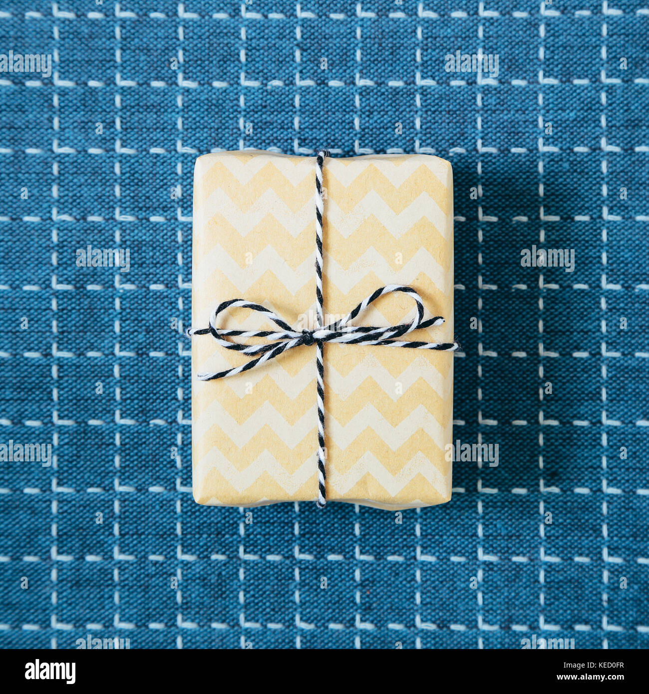 Gift box on navy color fabric background Stock Photo - Alamy