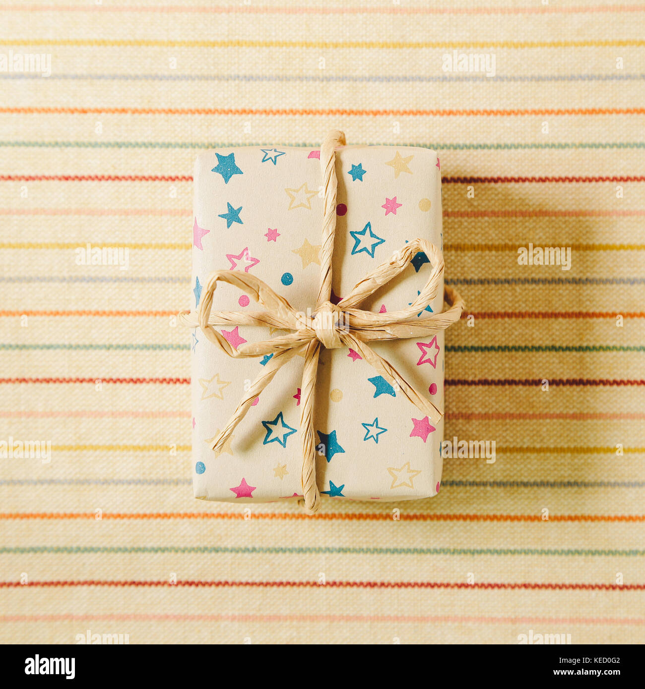 Gift box on stripe fabric background Stock Photo - Alamy