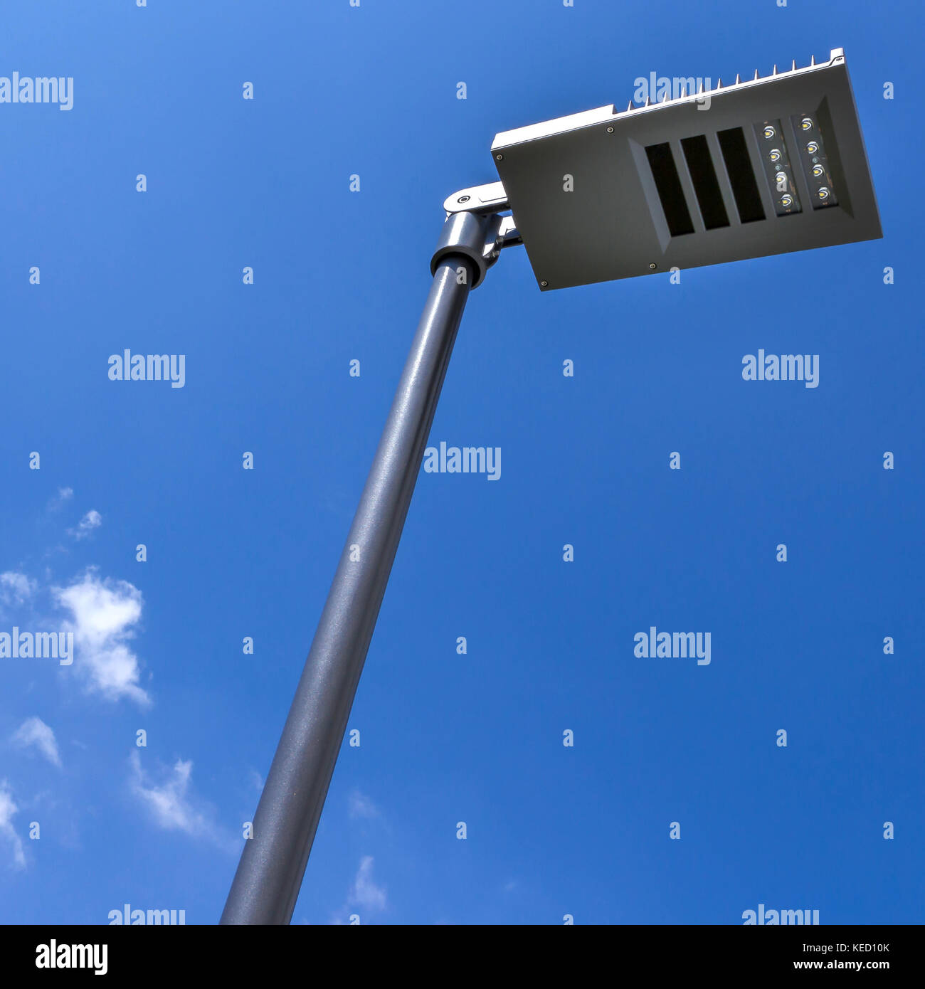 Modern electric street light pole over blue sky with clouds Stock Photo ...