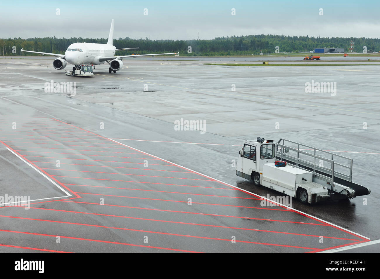 Airport runaway with airplane on a rainy day. Travel background Stock ...