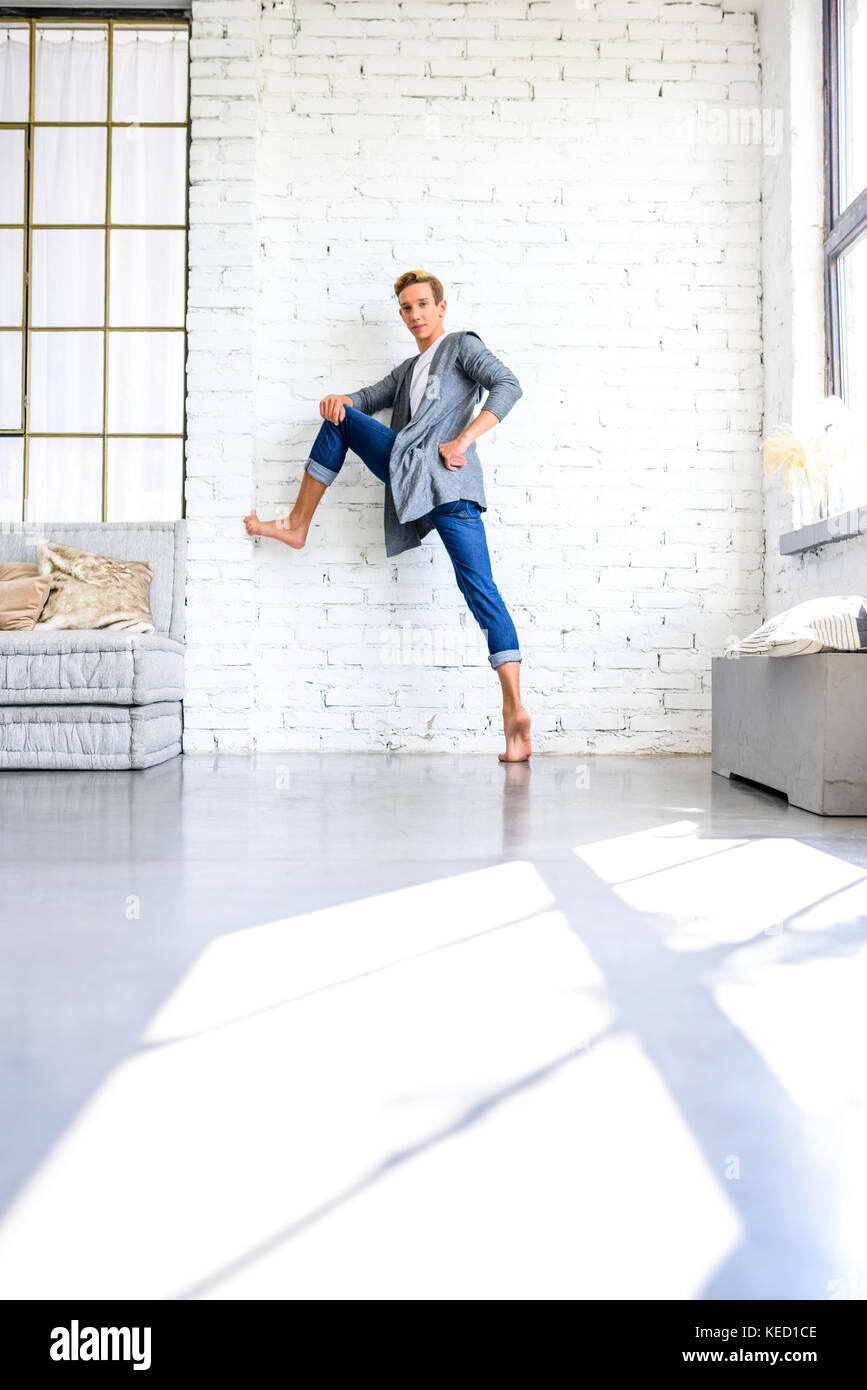A handsome young male Ballet dancer practicing in a Loft style ...